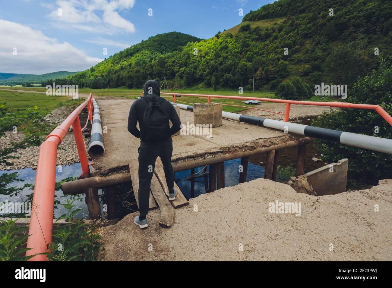 Businessman rebuilding a broken bridge. a man crosses a broken bridge ...