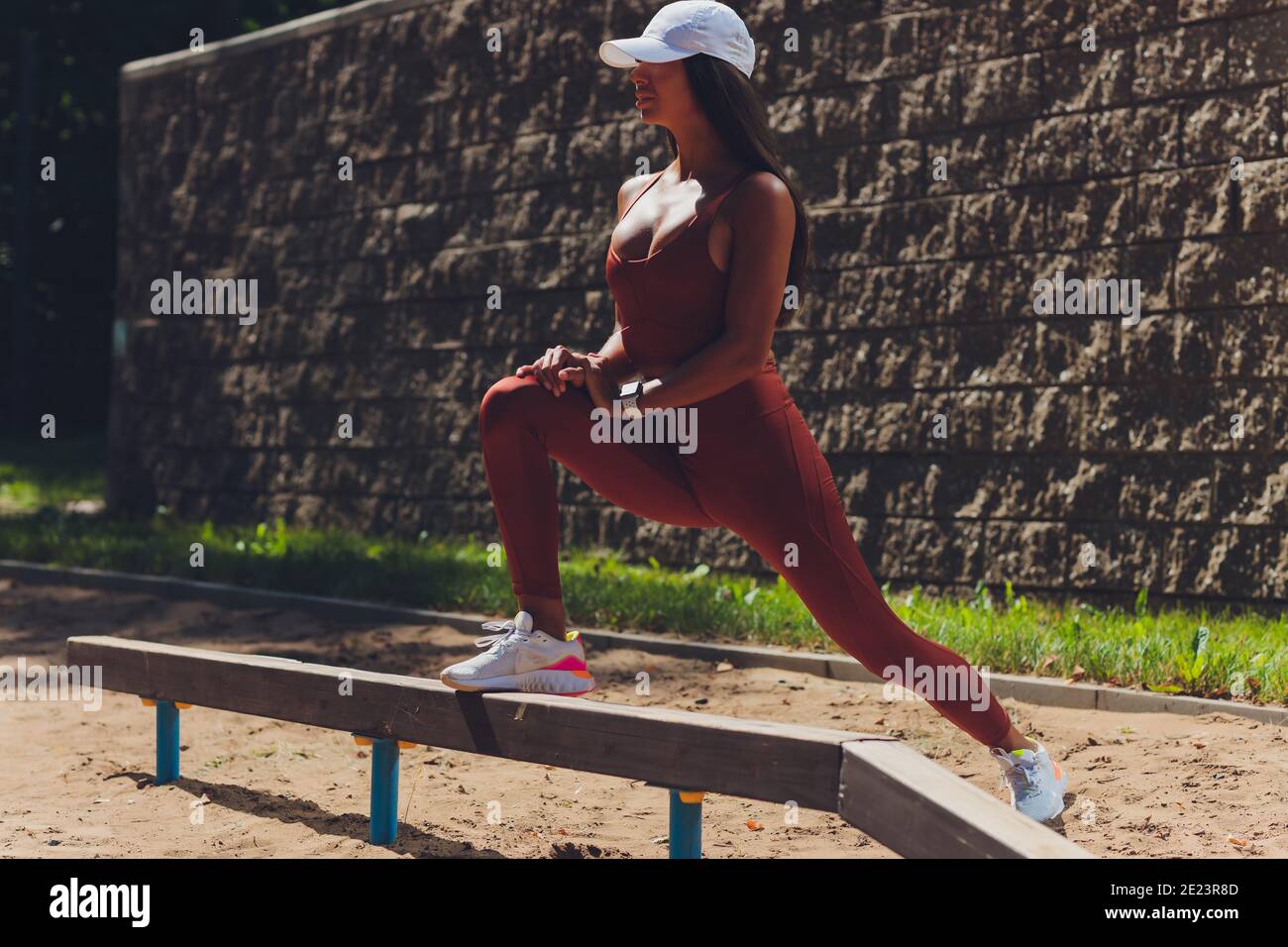 A beautiful young woman is engaged in sports on a street simulator ...