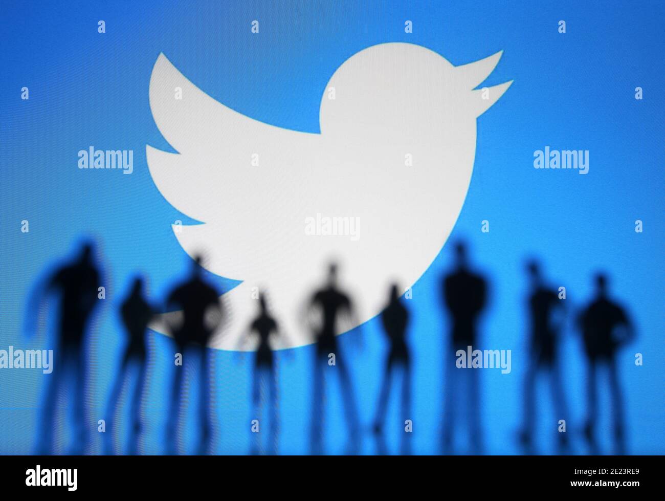 In this photo illustration a Twitter logo is seen displayed in front of ...