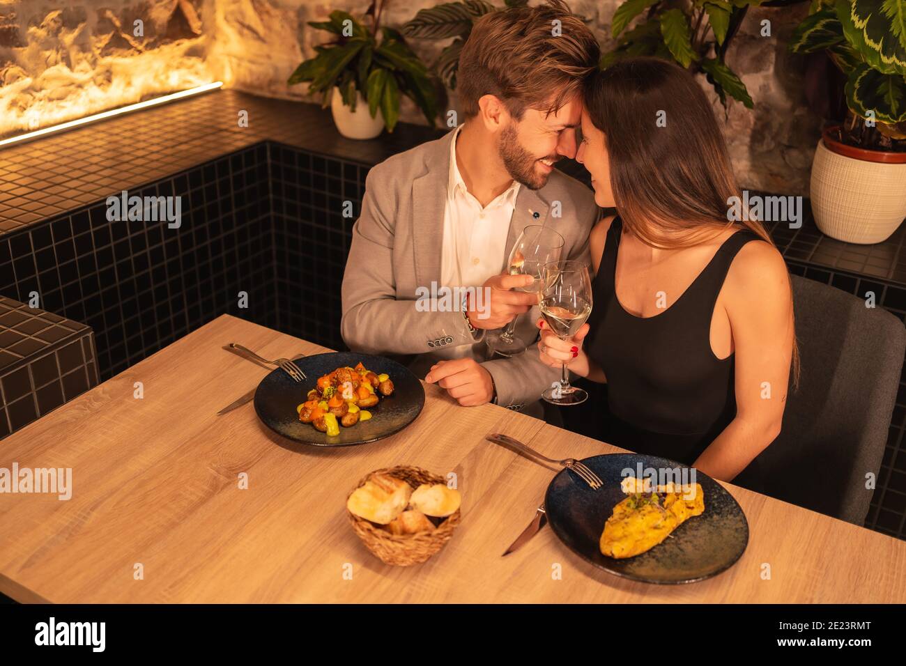 Happy loving couple enjoying dinner in a restaurant Stock Photo - Alamy