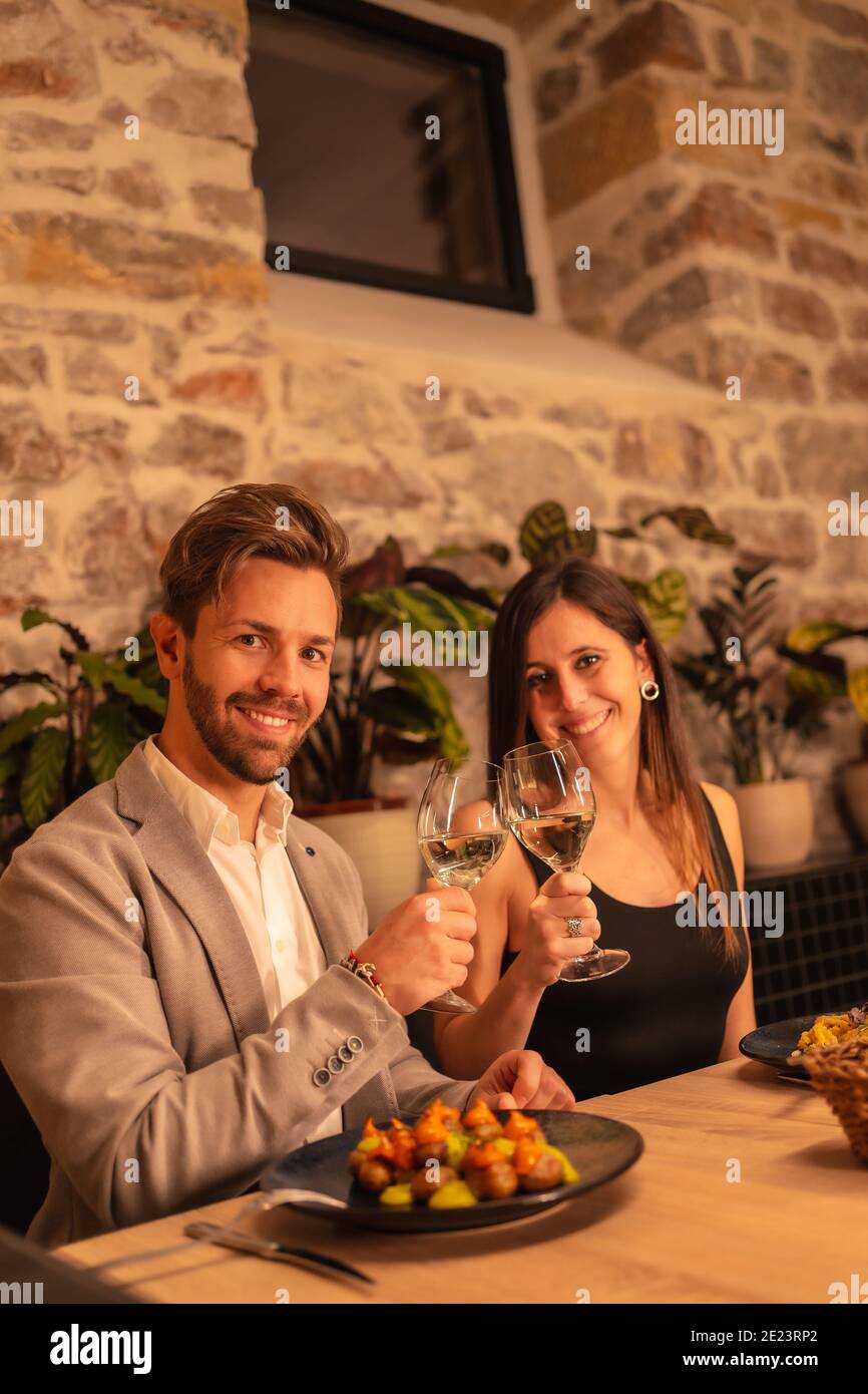 Happy loving couple enjoying dinner in a restaurant Stock Photo - Alamy