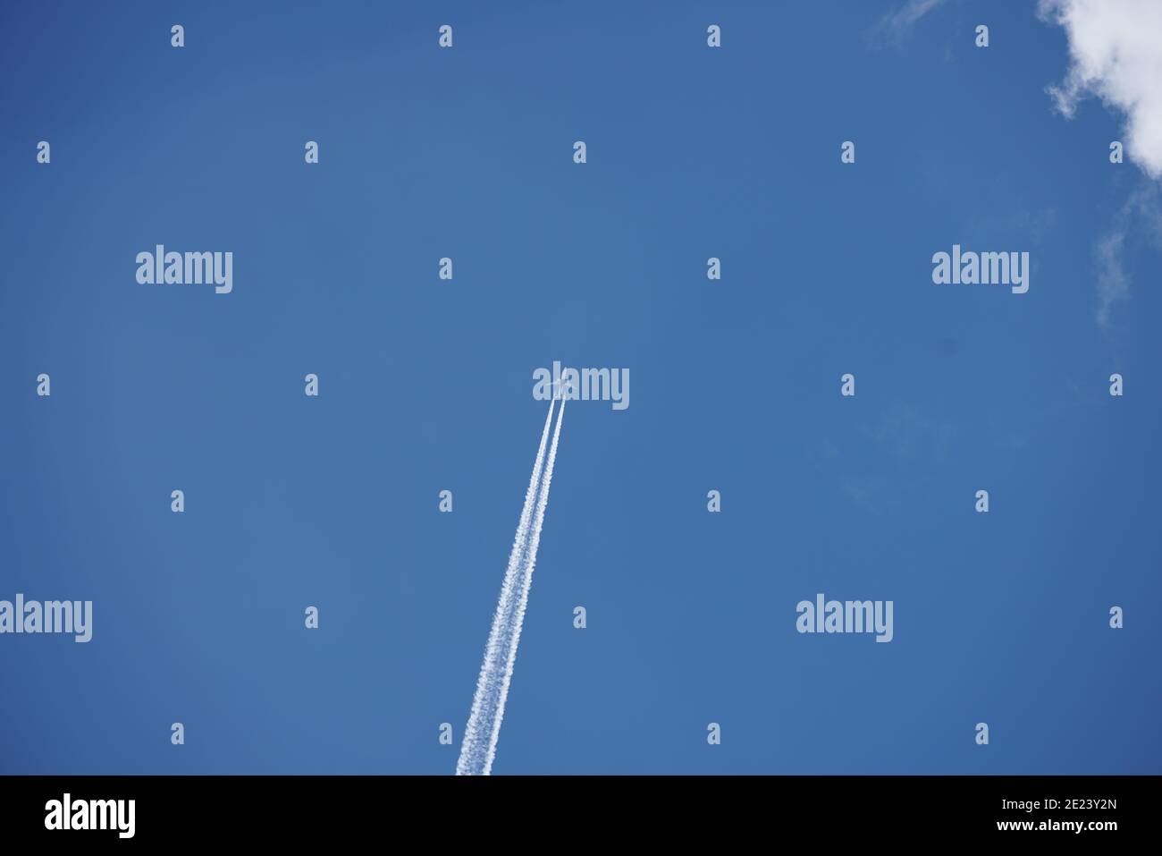 Horizontal shot of a plane leaving tracks in the blue sky Stock Photo ...
