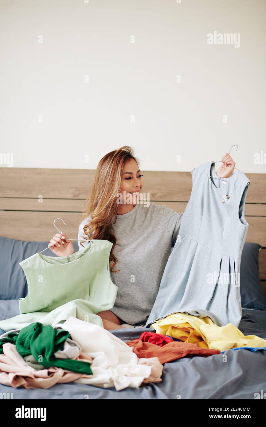 Woman deciding what to wear Stock Photo - Alamy