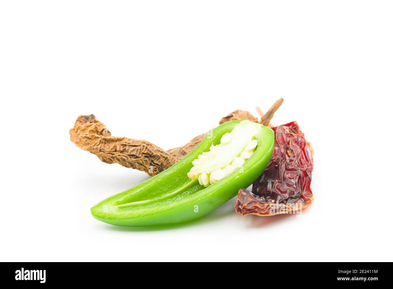 Closeup of a fresh green jalapeno and dried chili pepper isolated on a ...