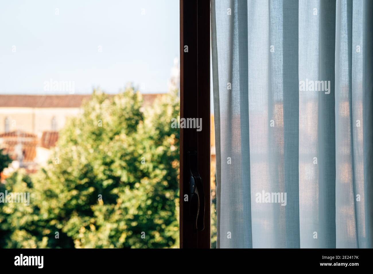 View of green trees from open window Stock Photo - Alamy