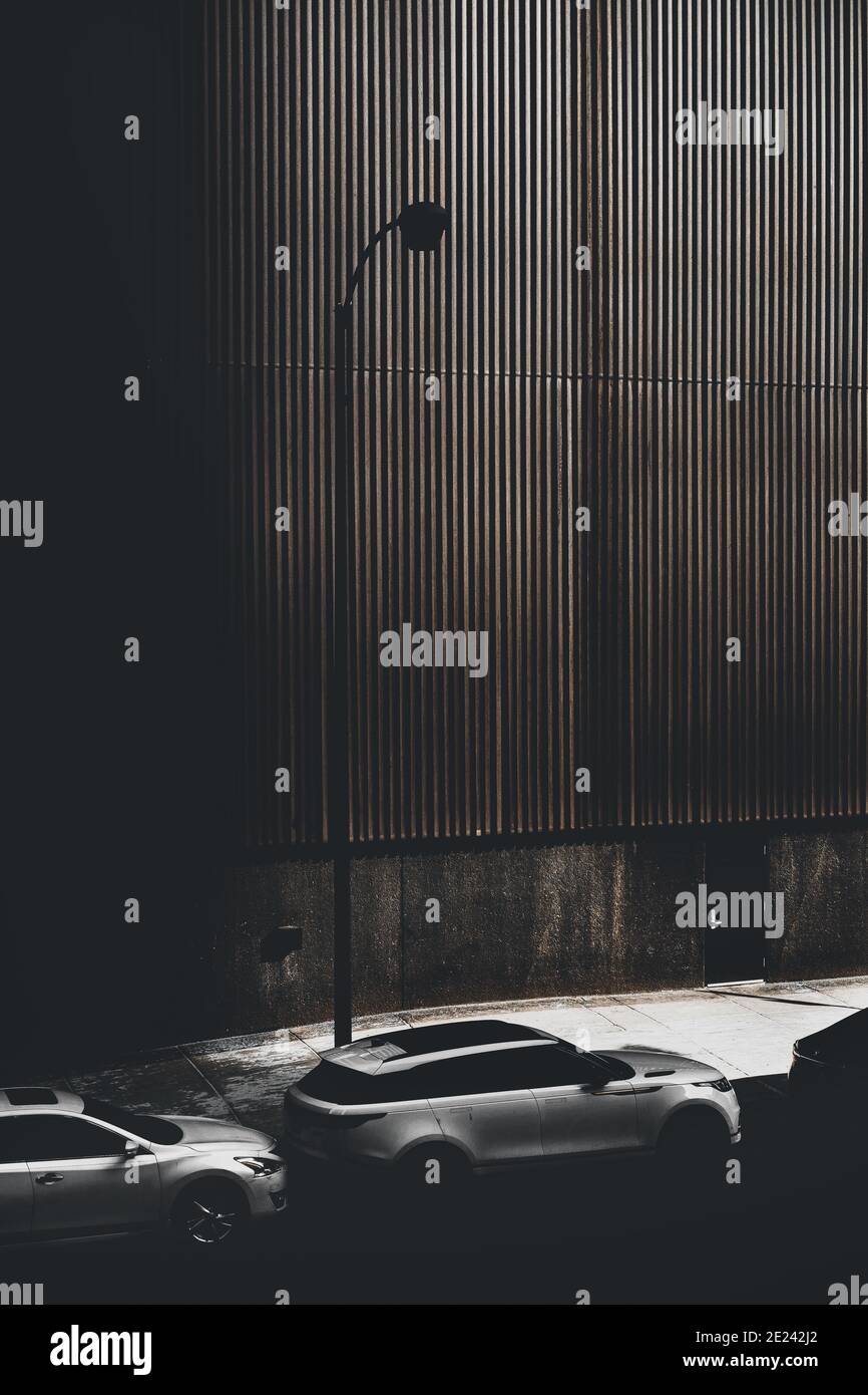 Vertical shot of cars parked next to a modern building - perfect for ...