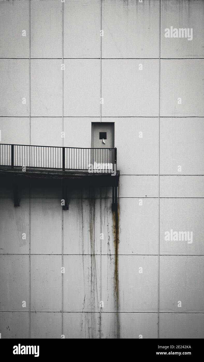 Vertical shot of a fire escape path and exit door installed outside the ...