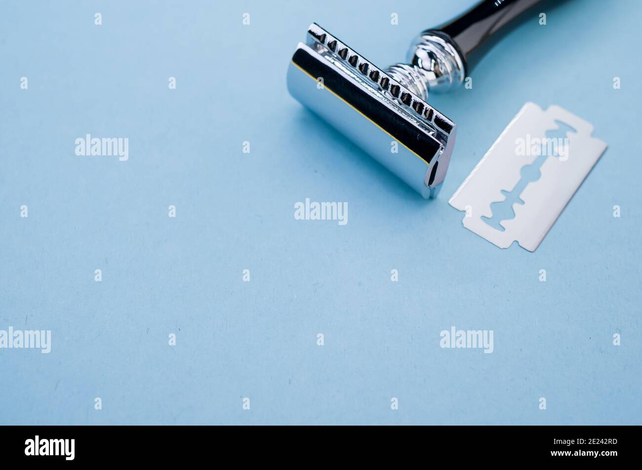 Top view of a mechanical razor and blade isolated on blue background ...