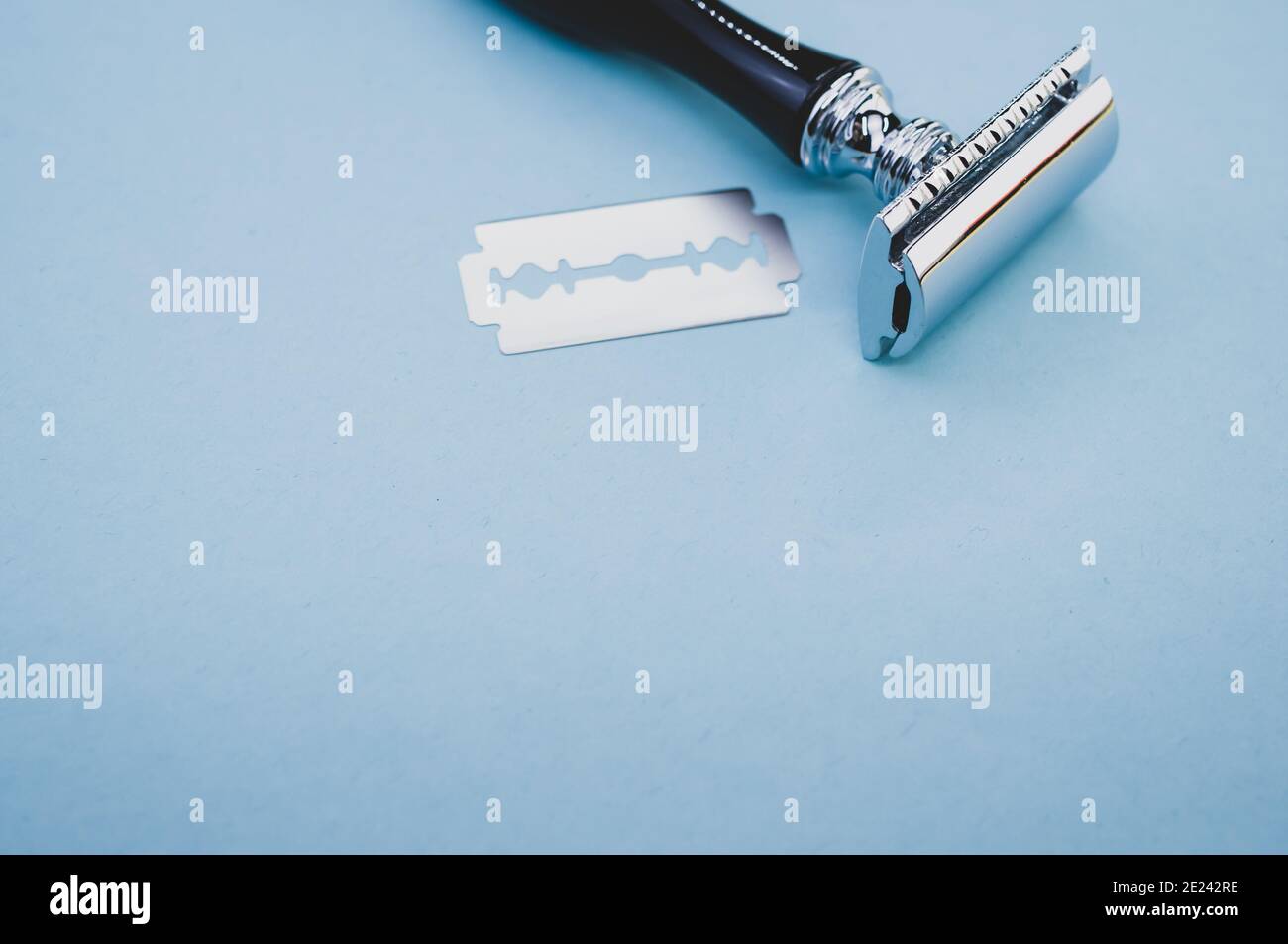 Top view of mechanical razor and blade isolated on blue background ...