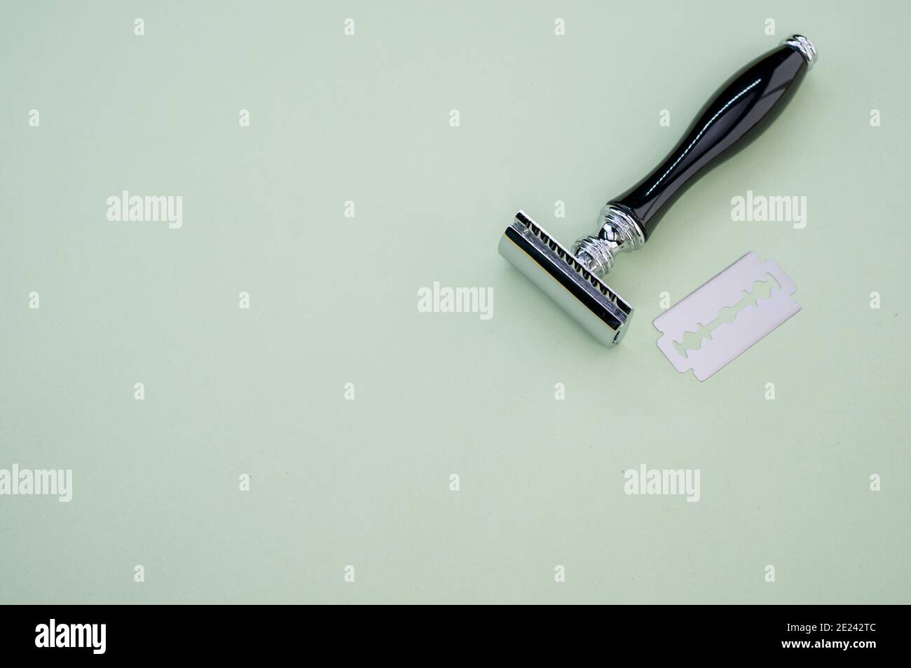 Top view of mechanical razor and blade isolated on light green ...