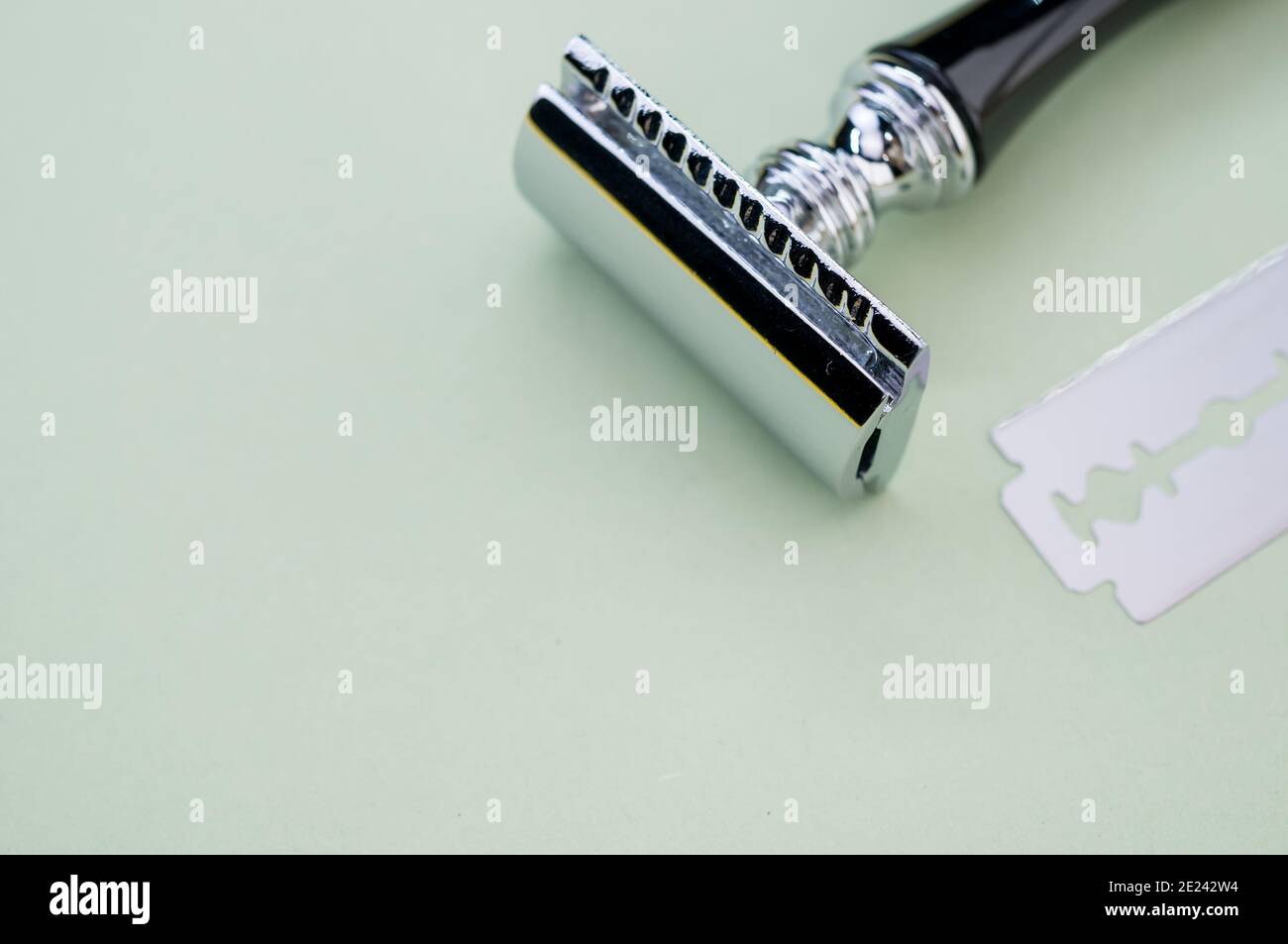 Top view of mechanical razor and blade isolated on light green ...