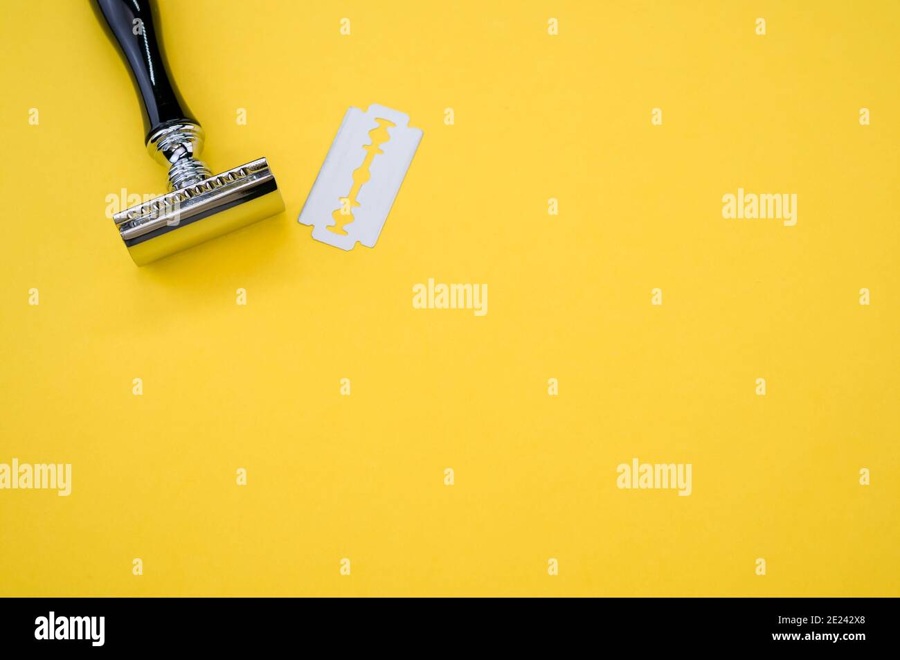 Top view of a mechanical razor and blade isolated on yellow background ...