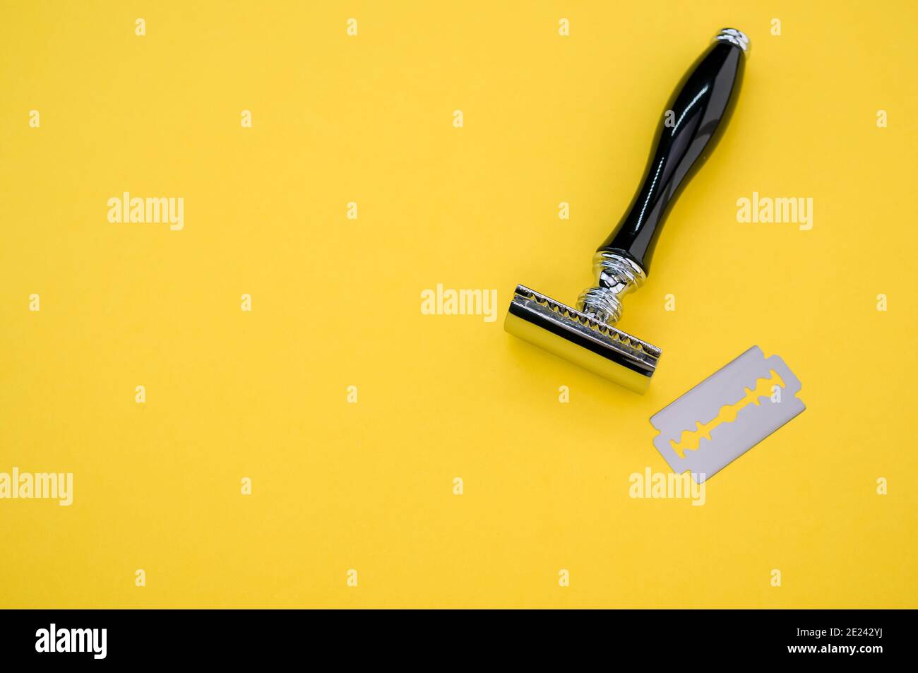 Top view of a mechanical razor and blade isolated on yellow background ...