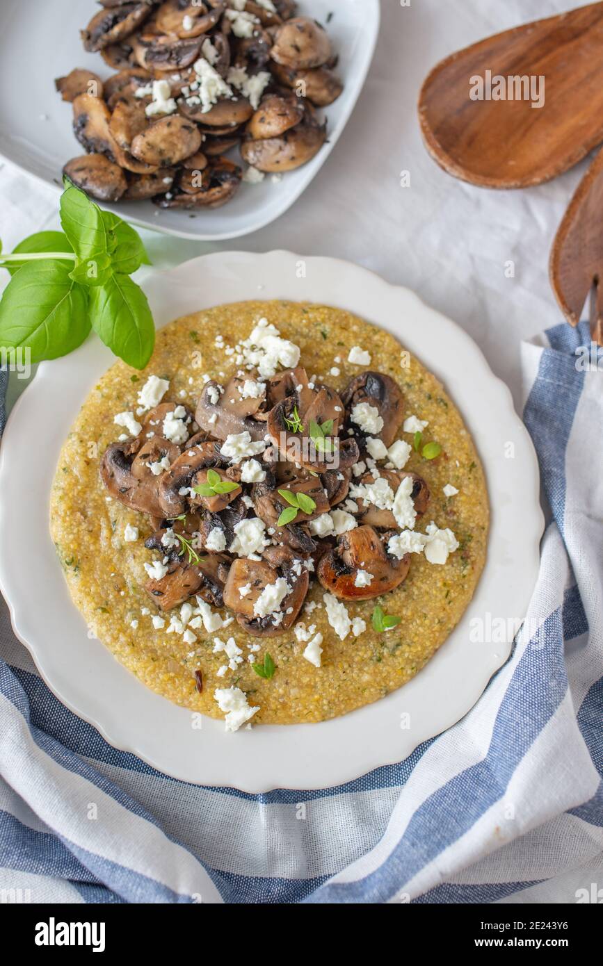 Traditional polenta with mushrooms and cheese Stock Photo - Alamy
