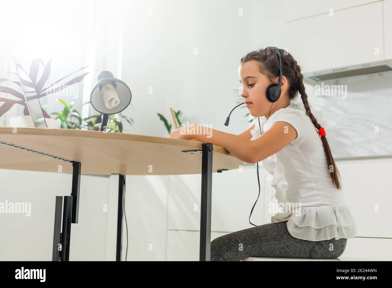 Kids distance learning. Cute little girl using laptop at home ...