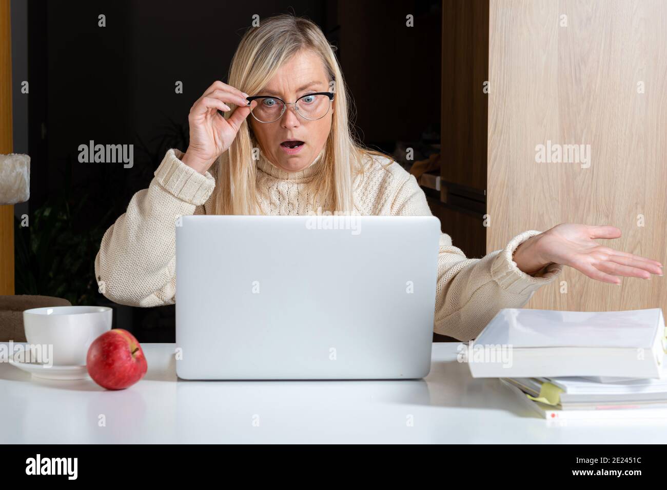 emotional freelancer woman working in home office, surprised staring at ...