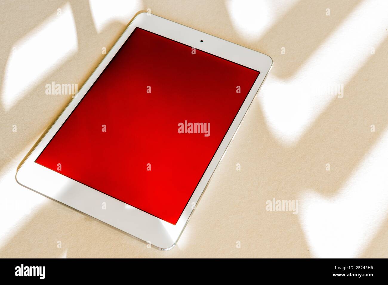 Tablet with red screen on a desk - copy space, technology concept Stock ...