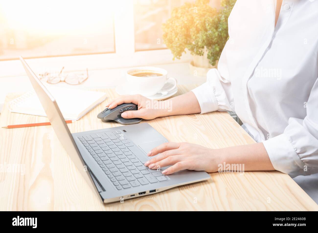 Freelance woman's hands on the keyboard laptop computer in a cafe, girl ...