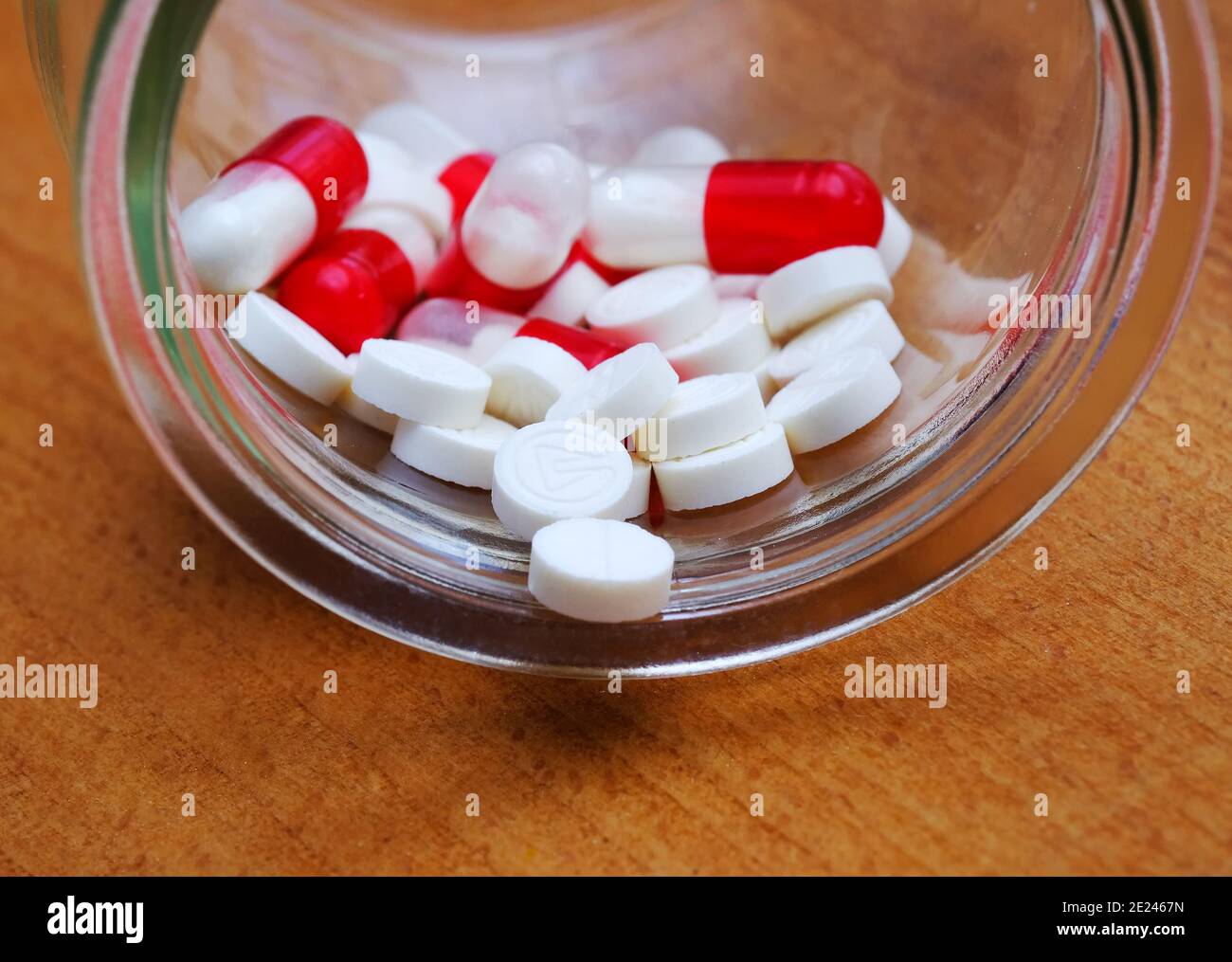 Round pills and pill bottle Stock Photo - Alamy