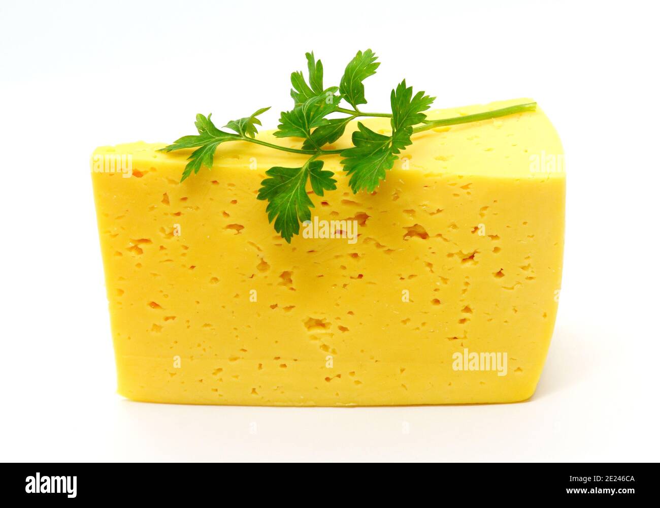 An isolated Russian cheese slab, semi hard cheese with small eyes ...