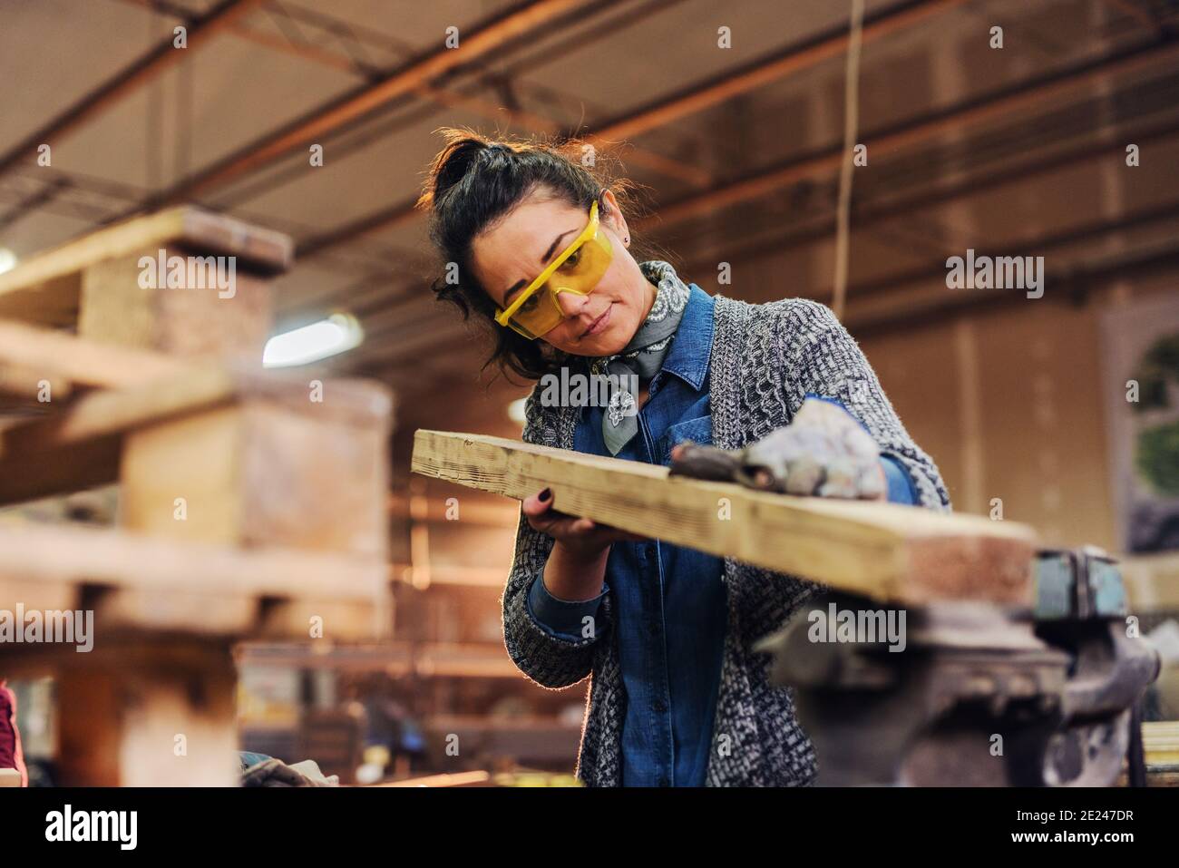 Picture of middle age focused female carpenter looking and choosing ...