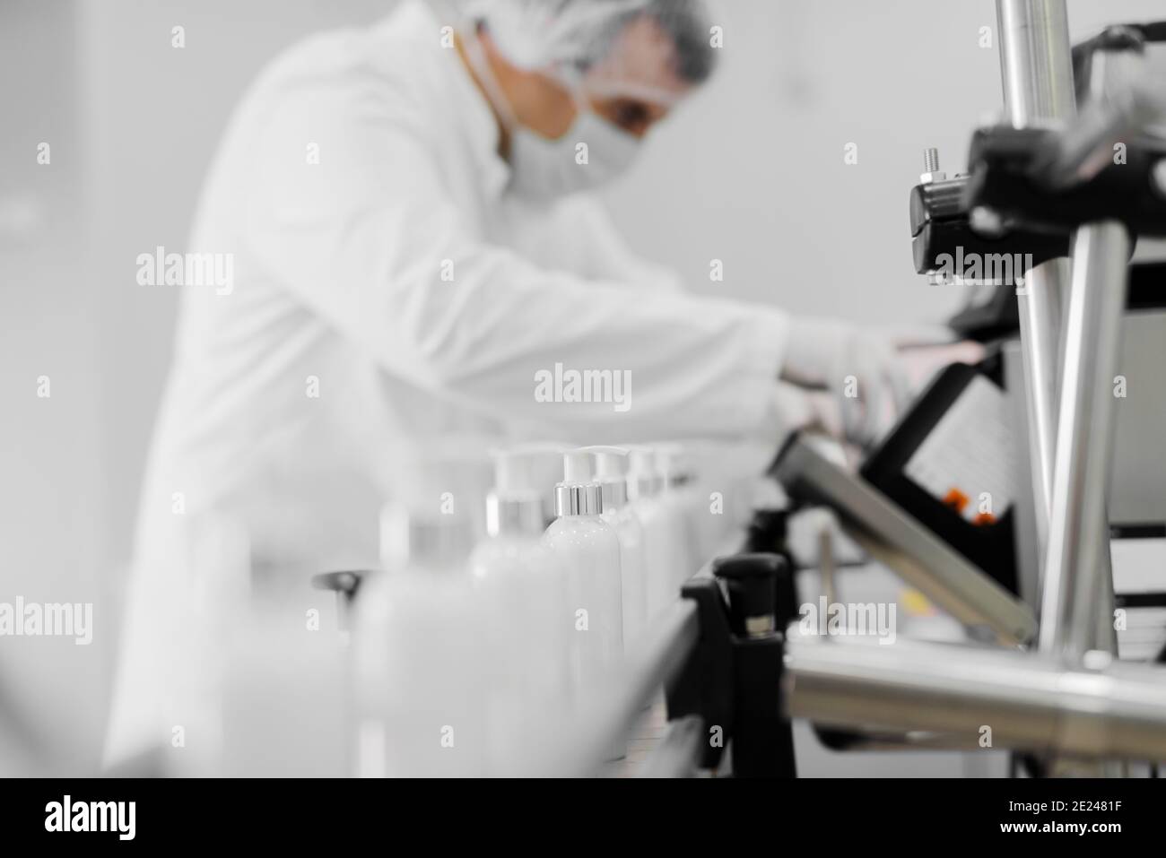 Picture of lotion bottles on production line. Bottles of cosmetic ...