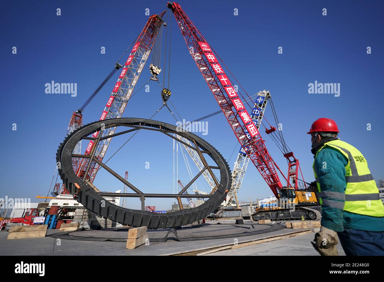 Beijing, China. 25th Dec, 2020. Workers install the component of a ...
