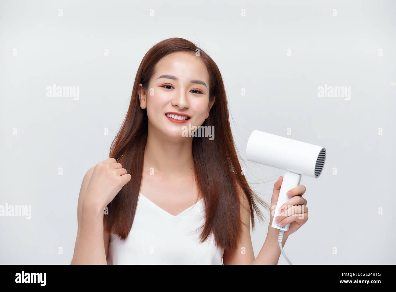 A young woman drying her hair Stock Photo - Alamy