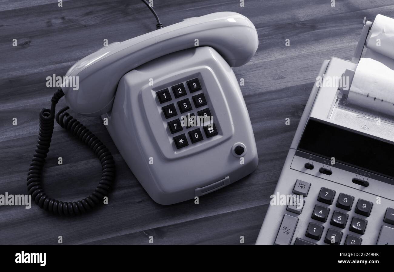 Old fashioned calculator and telephone on desk Stock Photo - Alamy