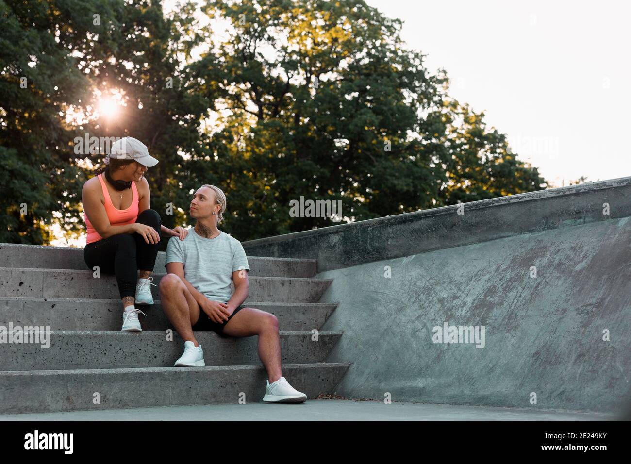 Two people sitting on stairs hi-res stock photography and images - Alamy