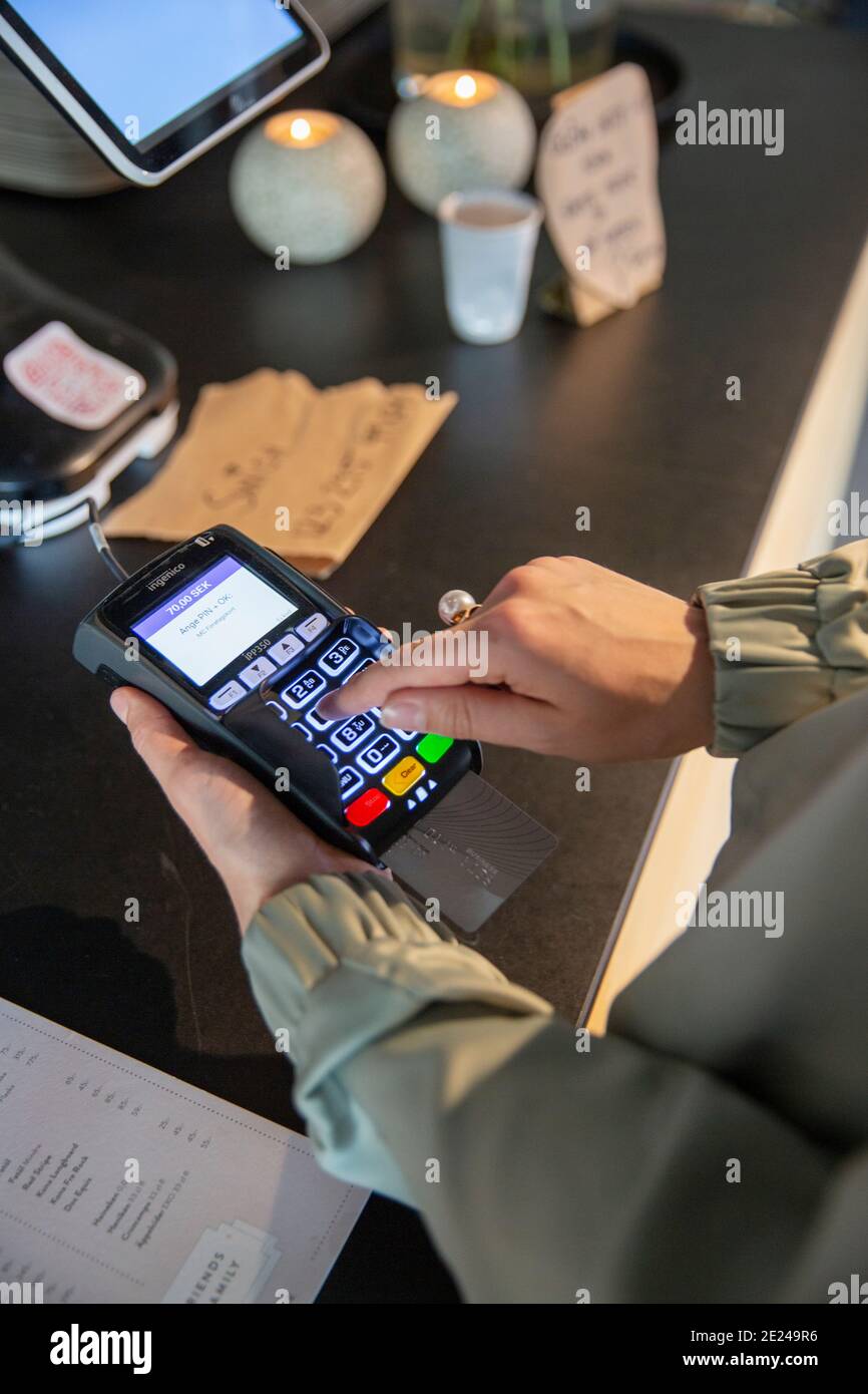 Hands holding credit card reader Stock Photo - Alamy