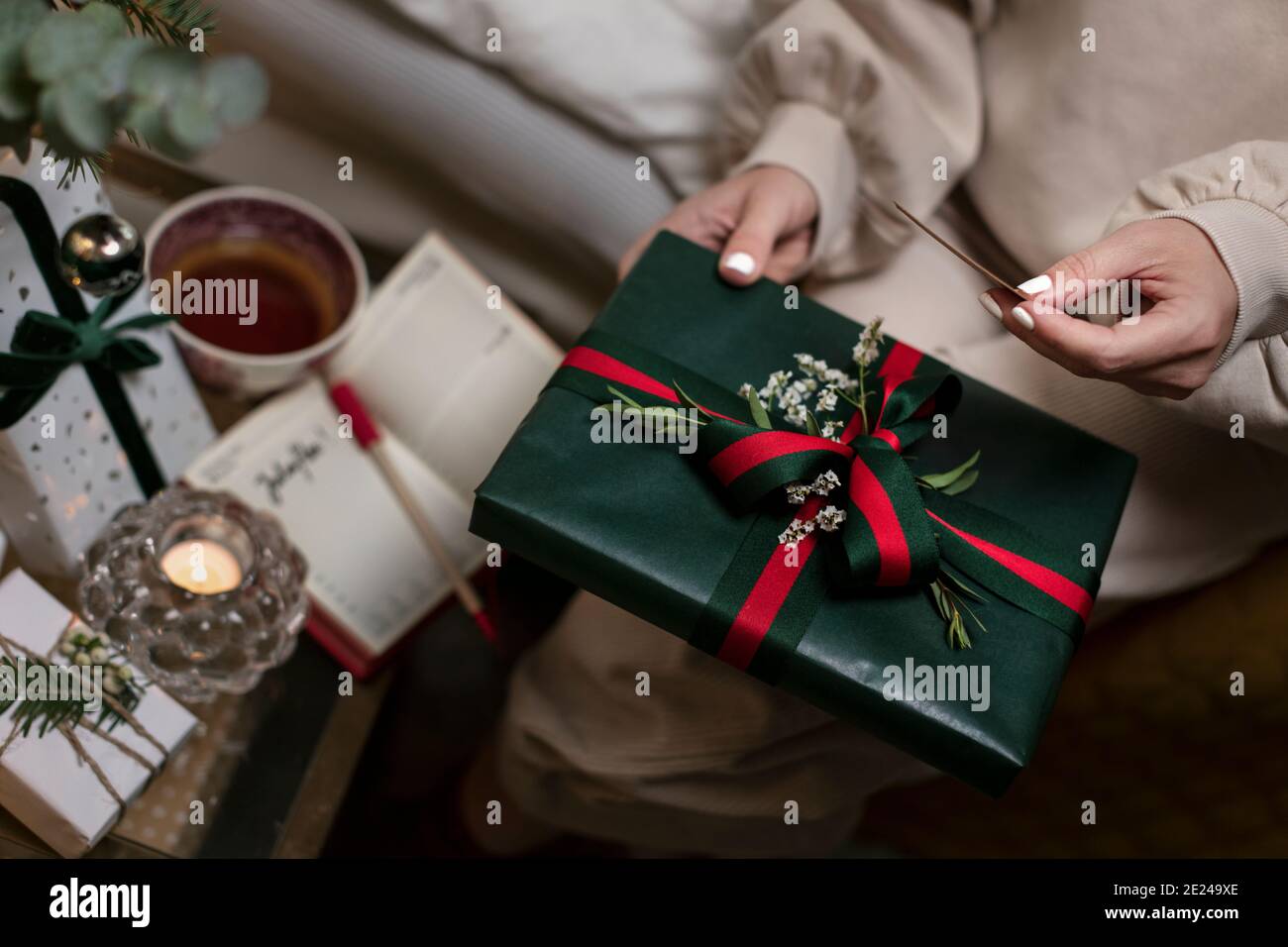 Womans hand holding present hi-res stock photography and images - Alamy