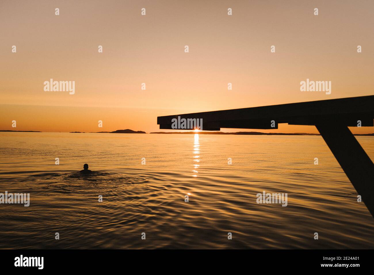 Silhouette of springboard at sunset Stock Photo - Alamy