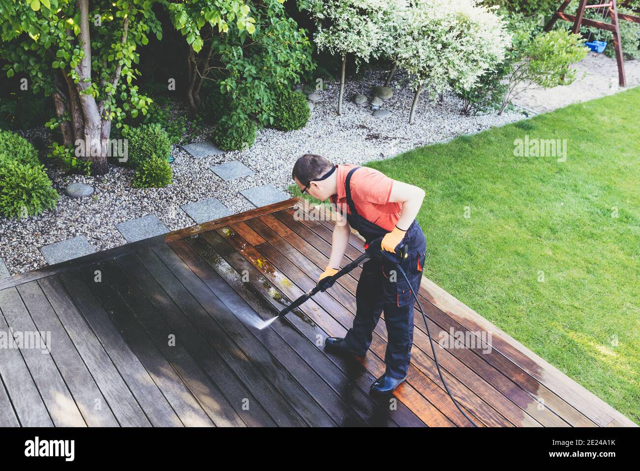 power washing - man cleaning terrace with a power washer - high water ...