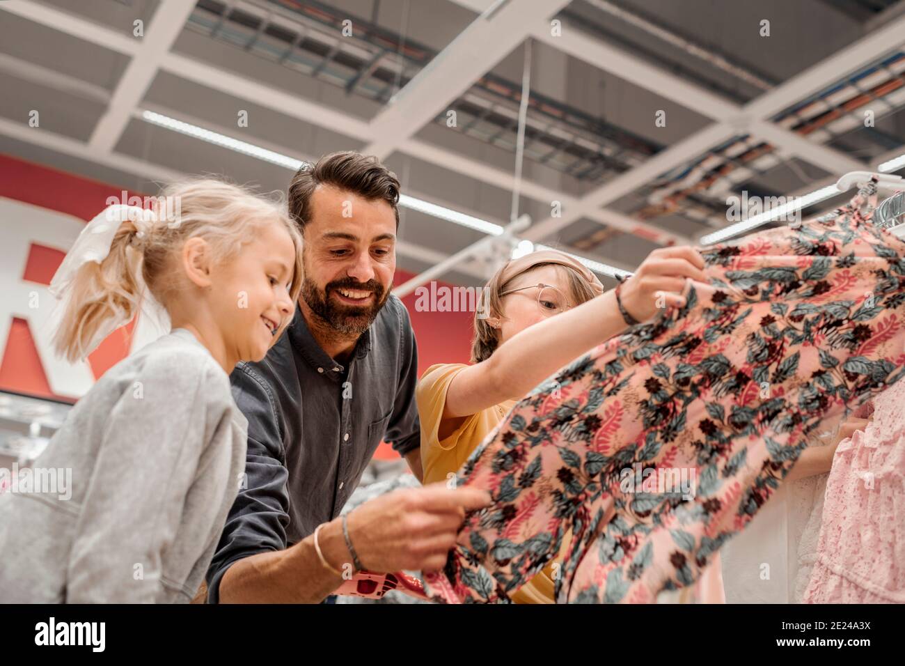 Father with daughters in shop Stock Photo - Alamy