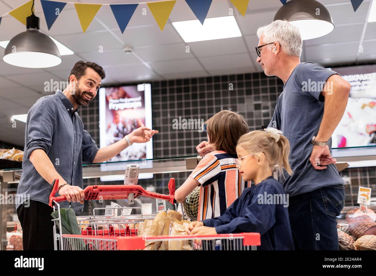 Customers talking in supermarket Stock Photo - Alamy