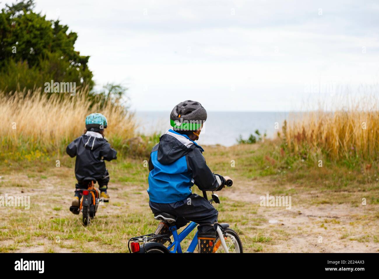 Children cycling at sea Stock Photo - Alamy