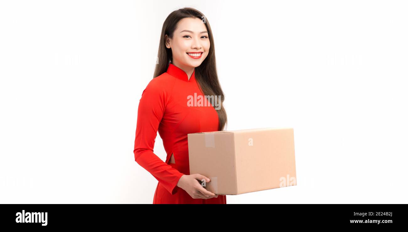 Woman in vietnamese traditional clothes giving gift box Stock Photo - Alamy