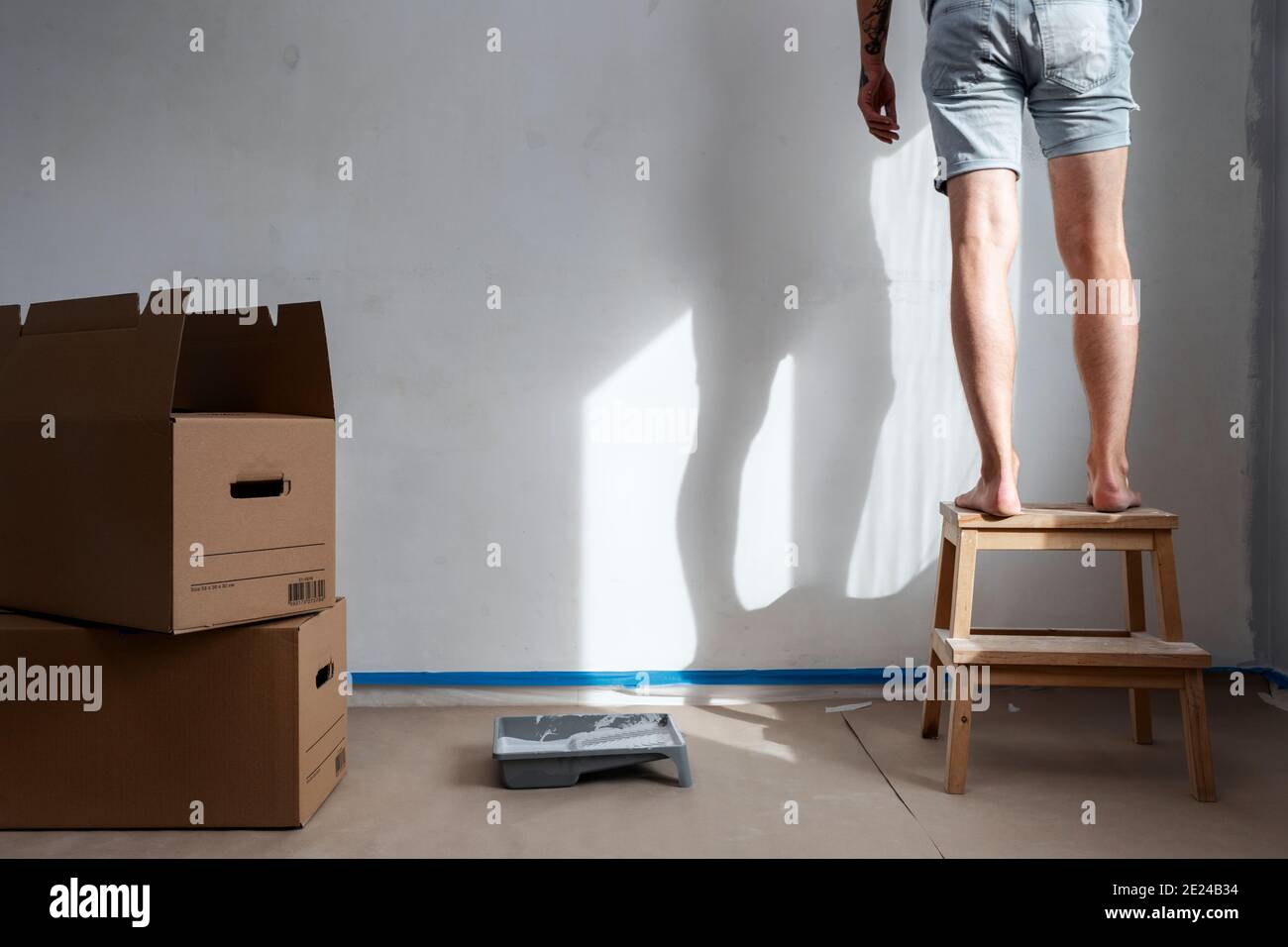 Low section of man standing on step stool Stock Photo - Alamy