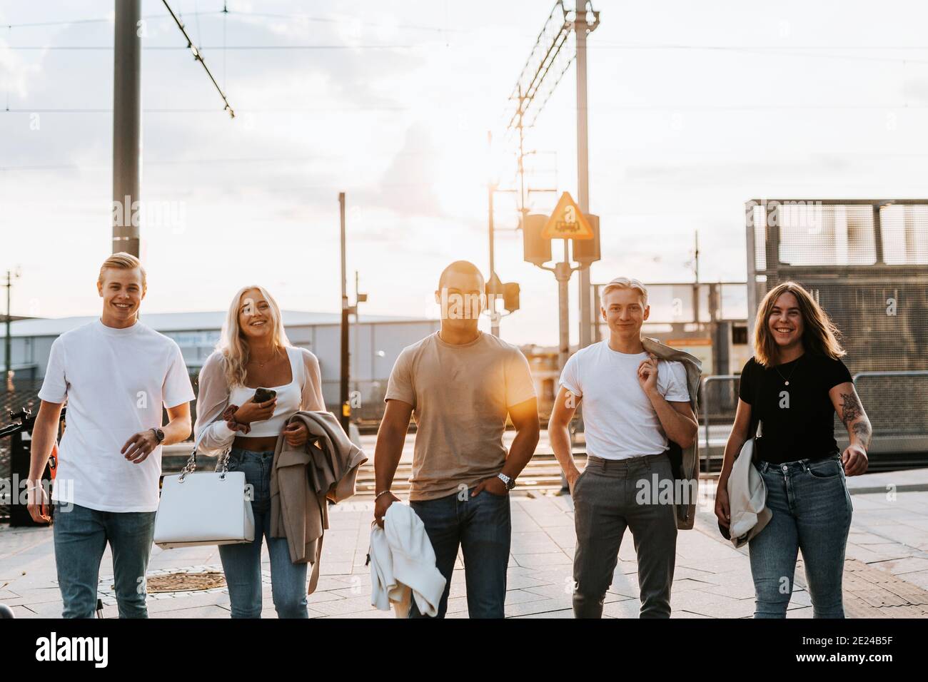 Smiling friends walking together Stock Photo - Alamy