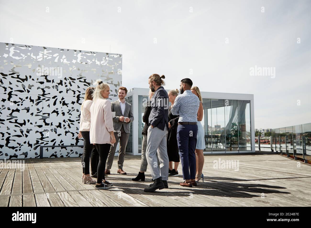 People standing in front of modern building Stock Photo - Alamy