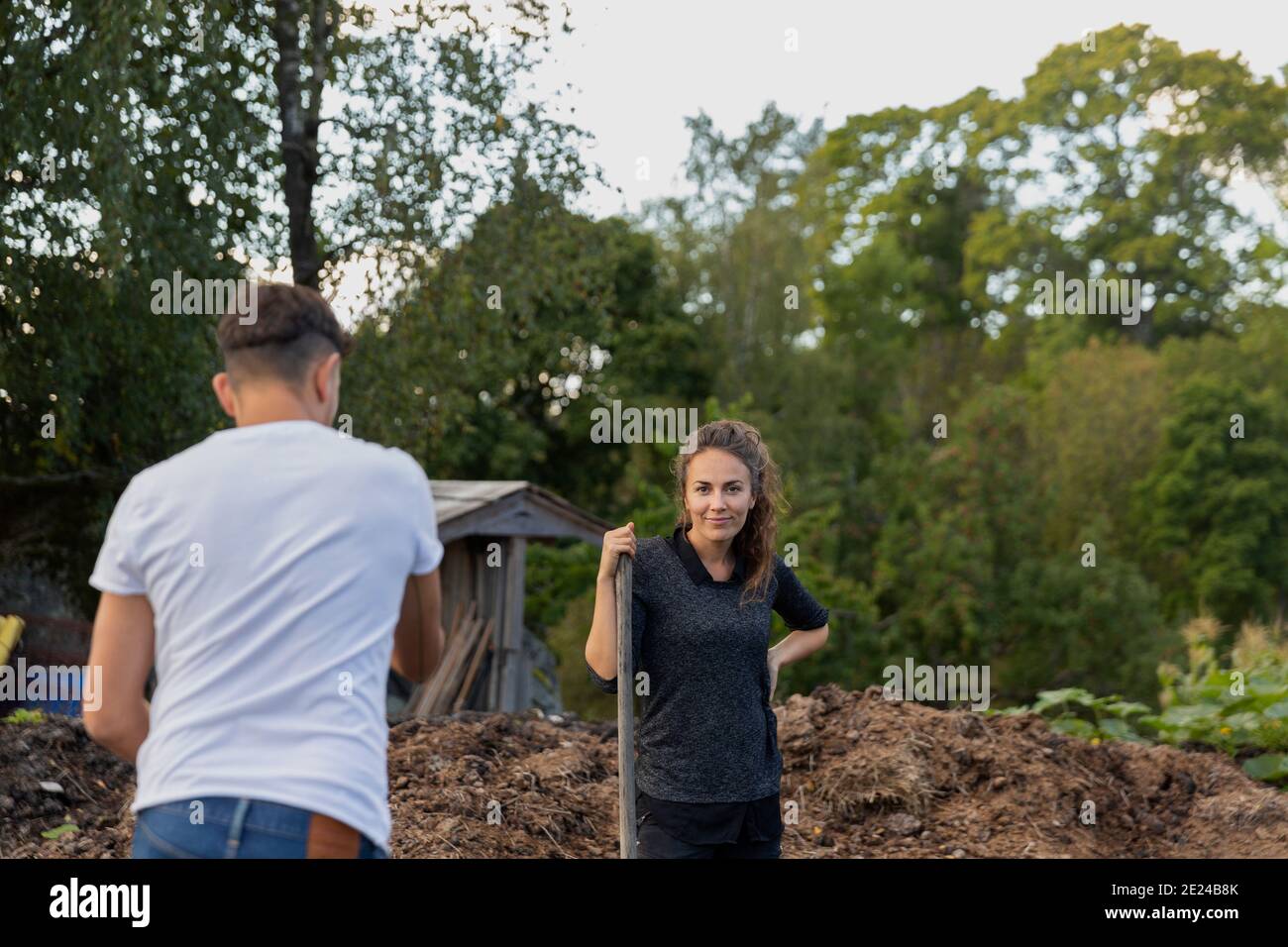 Young couple digging in garden Stock Photo - Alamy