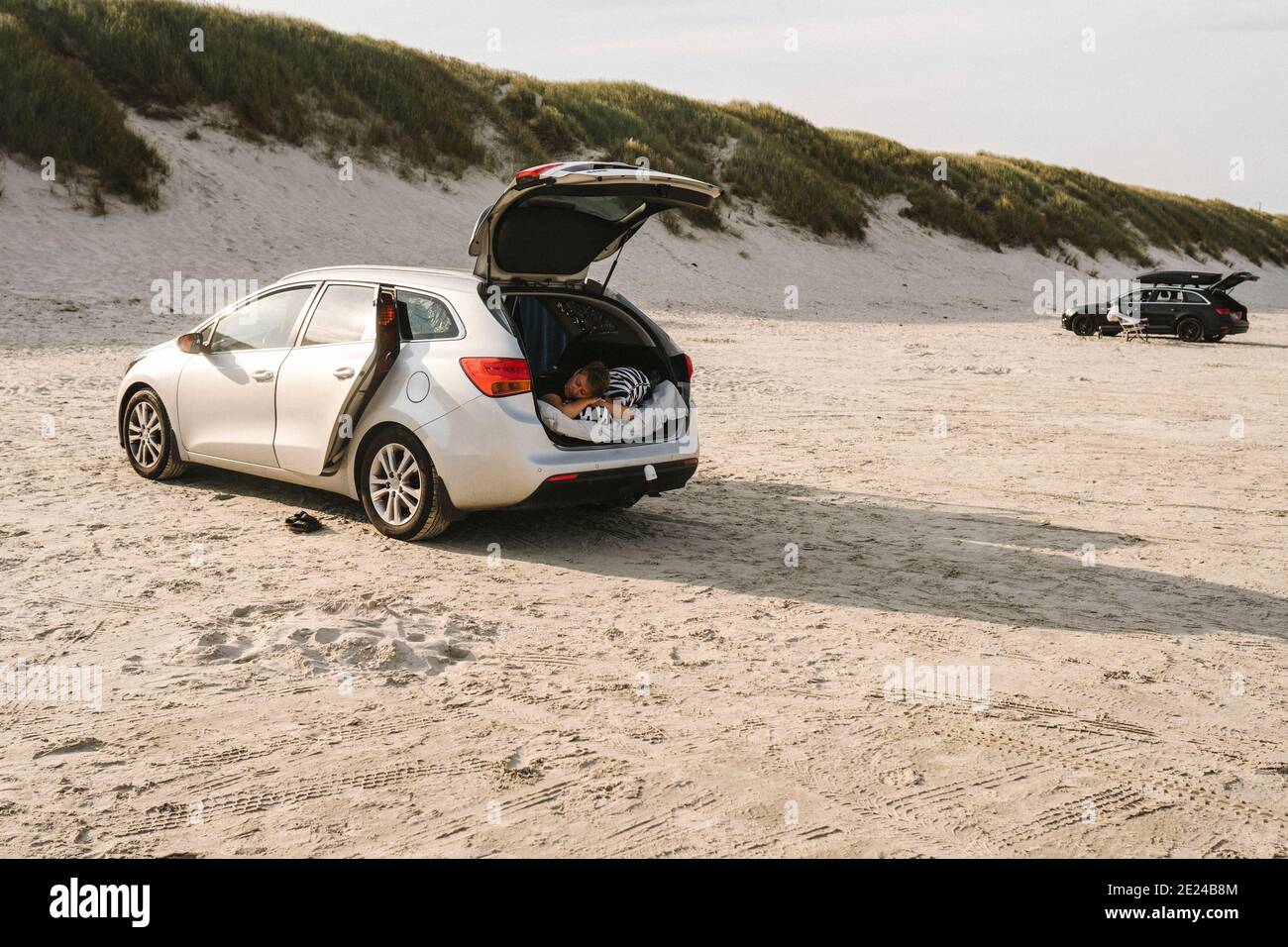 Car parked on sandy beach Stock Photo - Alamy