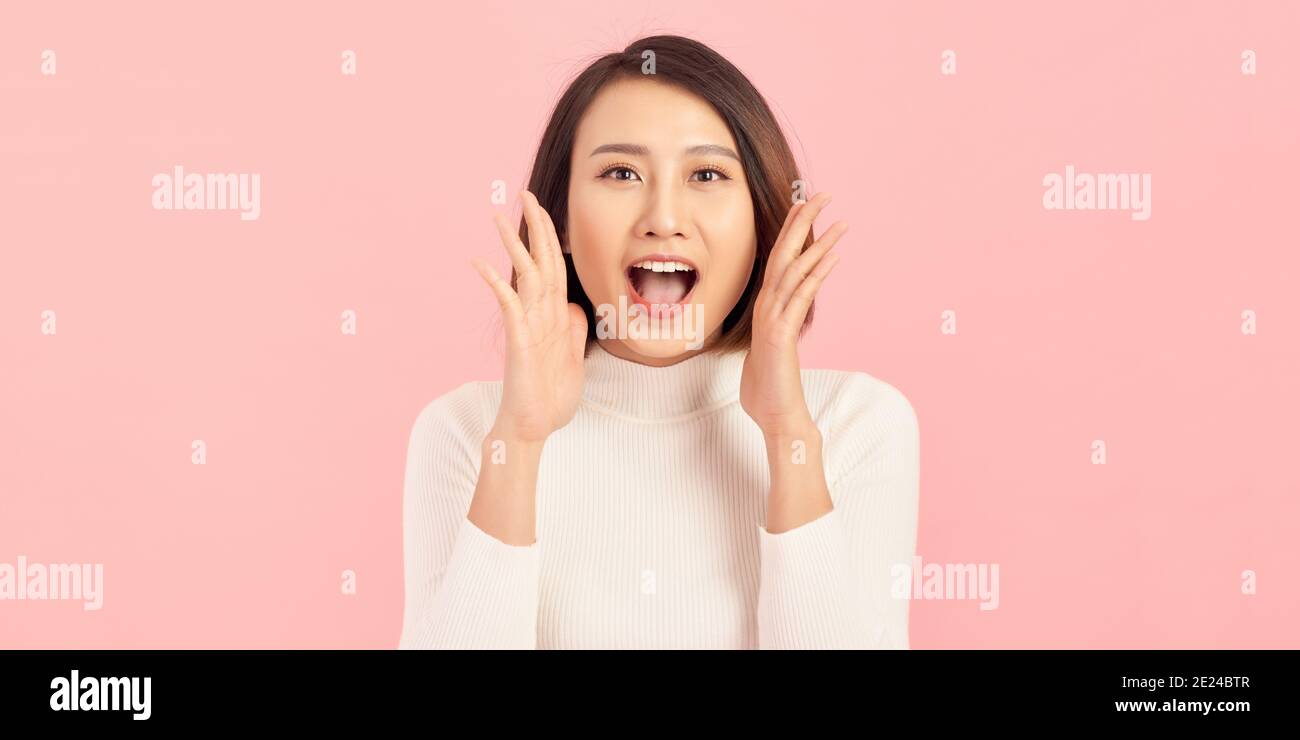 Energetic loud cute beautiful female opening mouth widely, putting ...