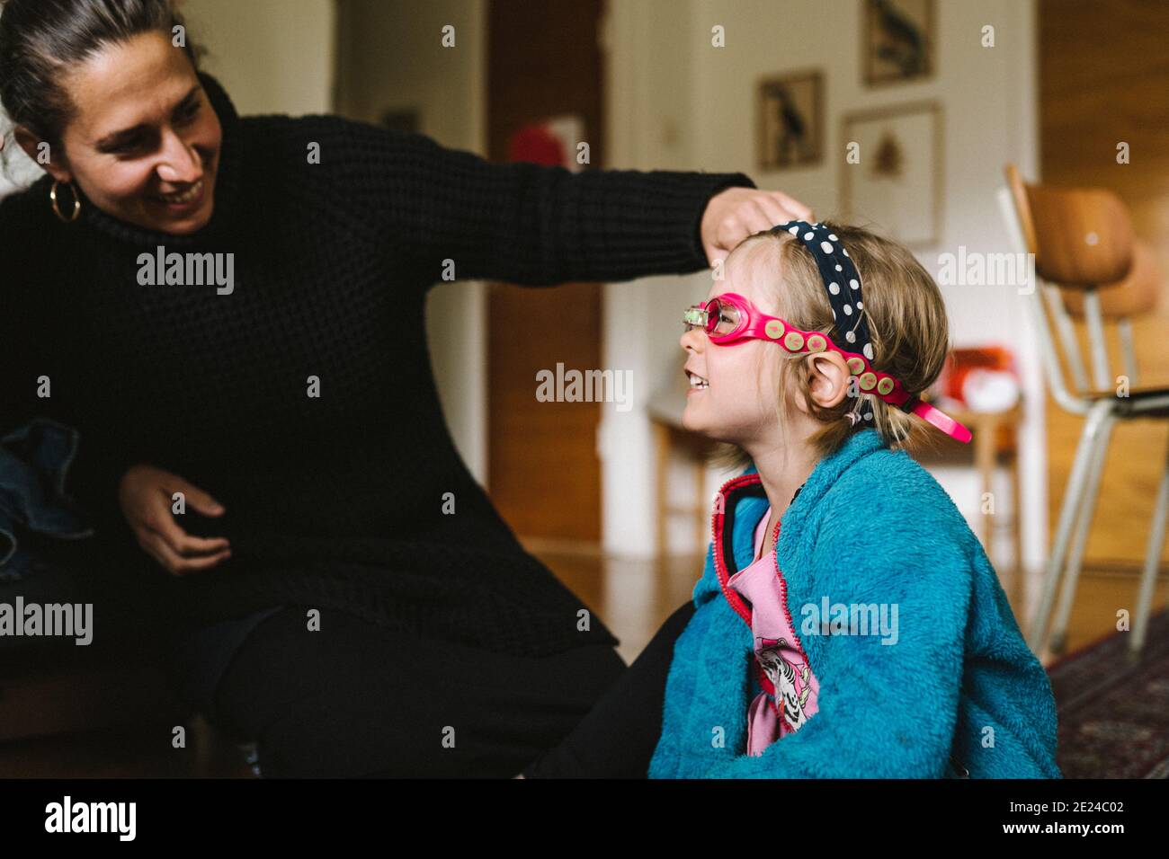 Mother looking at daughter wearing swimming goggles Stock Photo - Alamy