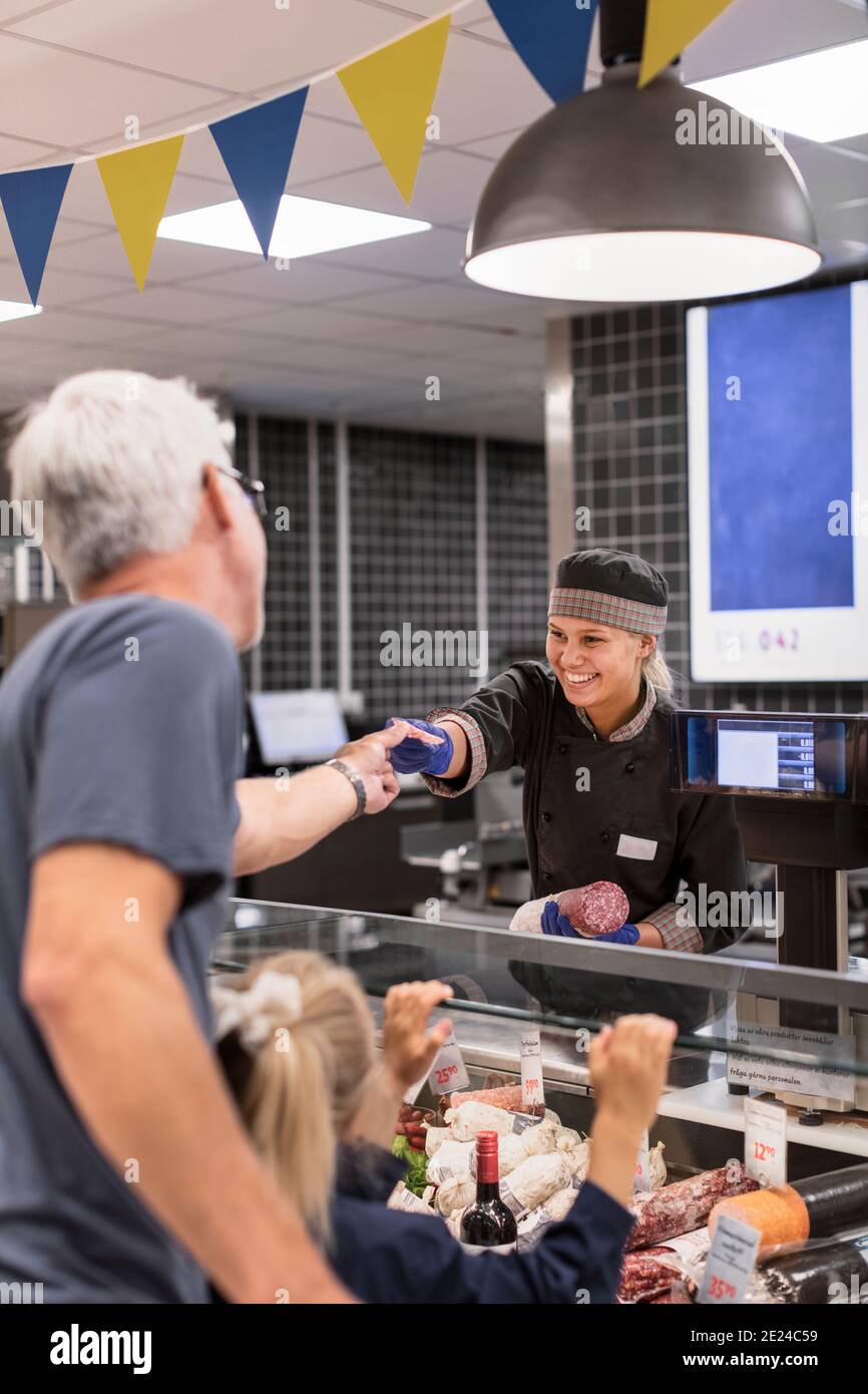 Customer at deli counter in supermarket Stock Photo - Alamy