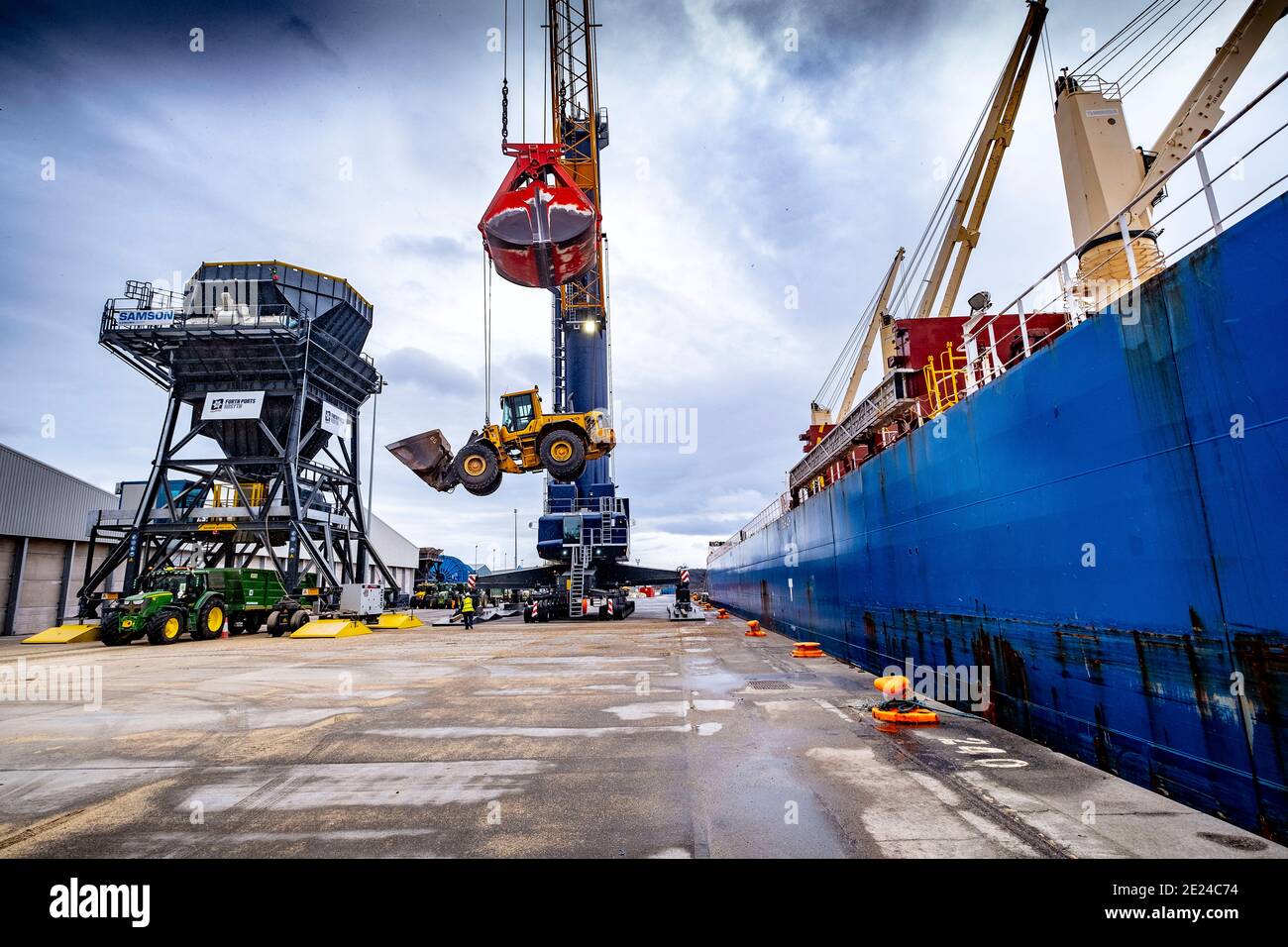 Grain being unloaded into a hopper at port Stock Photo - Alamy
