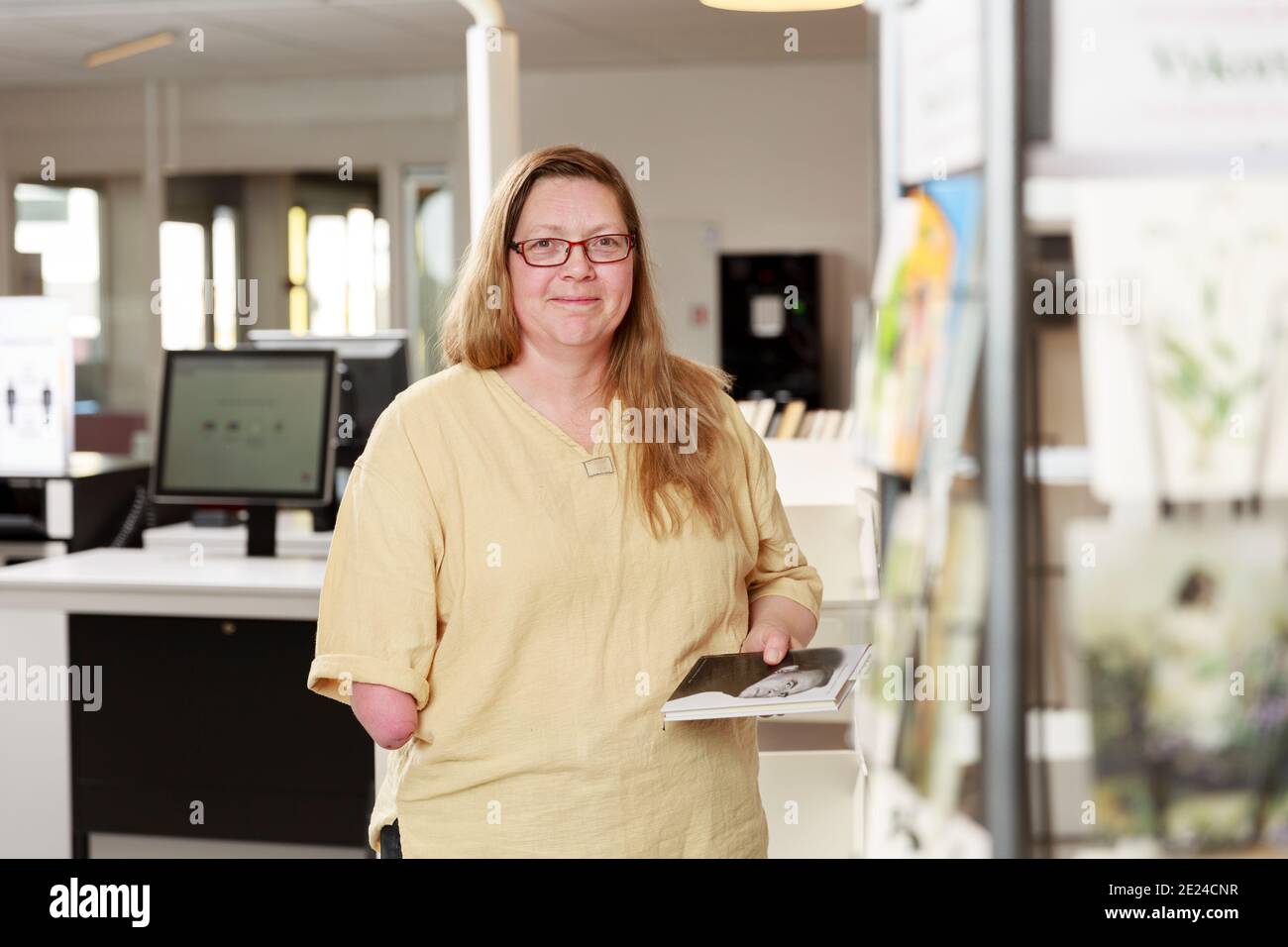 Librarian holding a book hi-res stock photography and images - Alamy