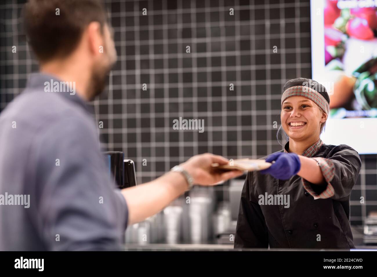 Smiling female shop assistant Stock Photo - Alamy
