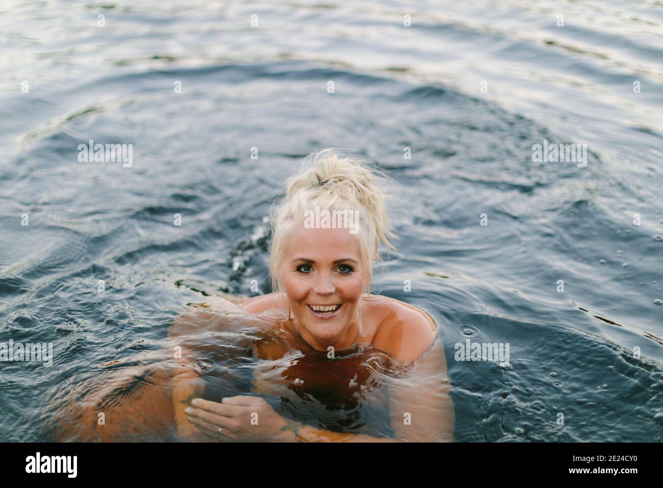 Woman swimming in sea Stock Photo - Alamy